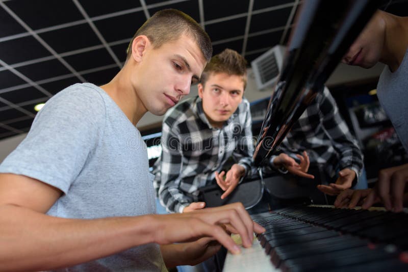 Young man playing piano stock photo. Image of piano - 117260604