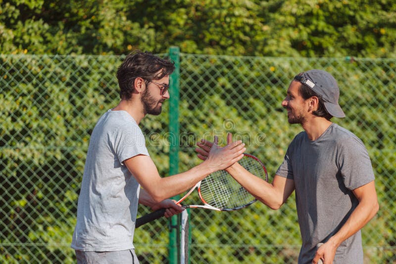 Young men playing tennis stock photo. Image of lifestyle - 78392994