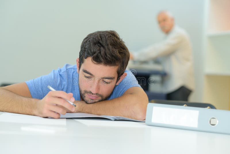 Young man taking exam stock image. Image of writting - 103742733