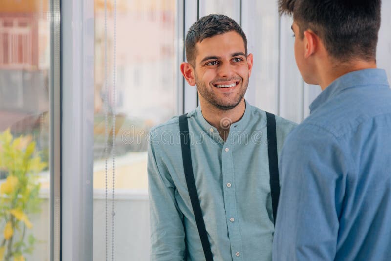 Young men talking indoors stock photo. Image of cooperation - 226700962