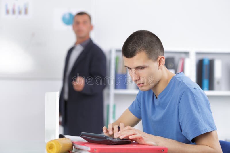 Young man using calculator stock photo. Image of calculation - 100425282
