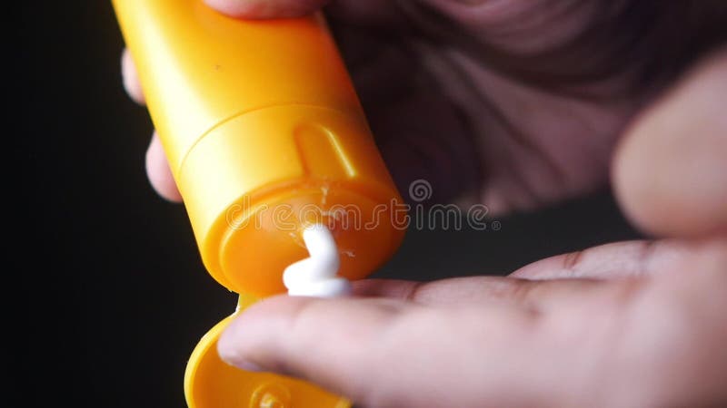 Young Men Using Sunscreen Cream Stock Footage - Video of container ...