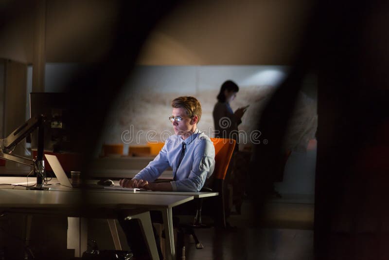 Man Working on Computer in Dark Office Stock Photo - Image of people ...