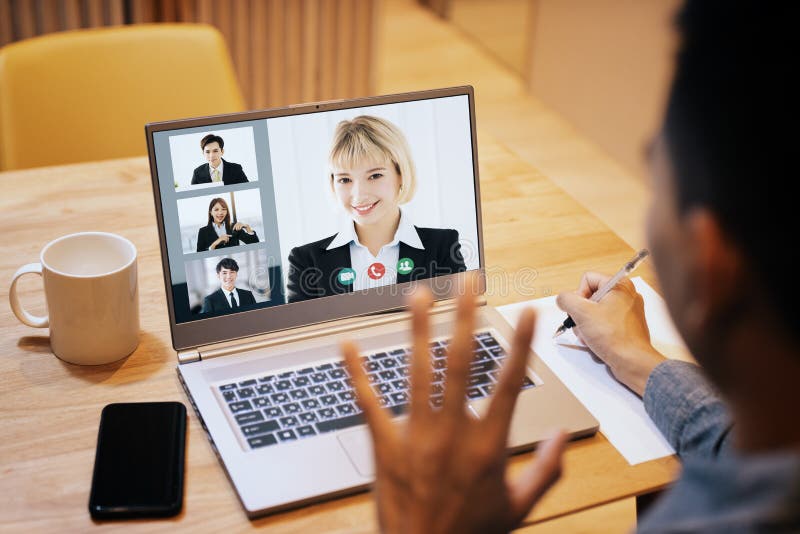 Young Man Working at Home and Using Laptop Computer with Video ...