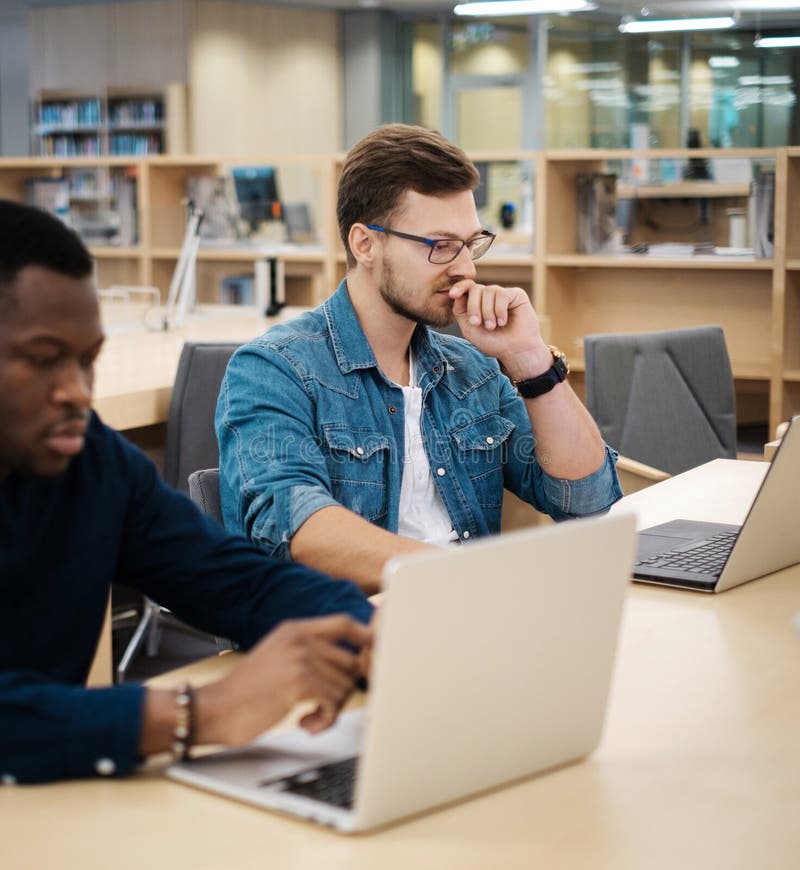 Young Men Working on a Laptops in Public Library Stock Photo - Image of ...