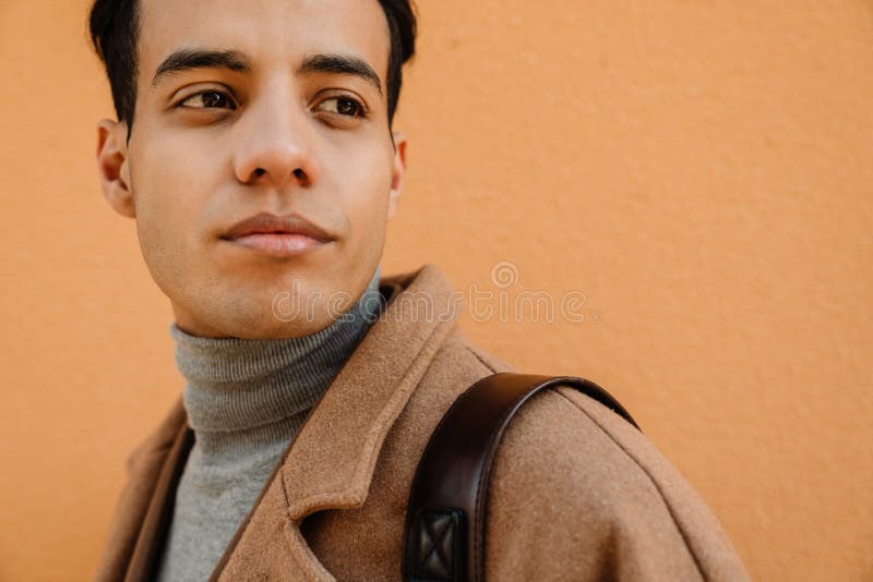 Young Middle Eastern Man Wearing Coat Standing by Wall Stock Image ...