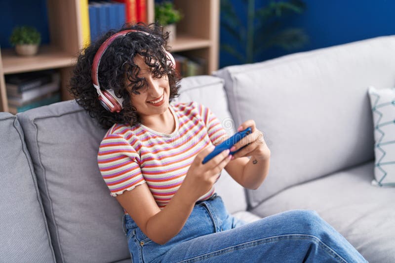 Young Middle Eastern Woman Playing Video Game Sitting on Sofa at Home ...