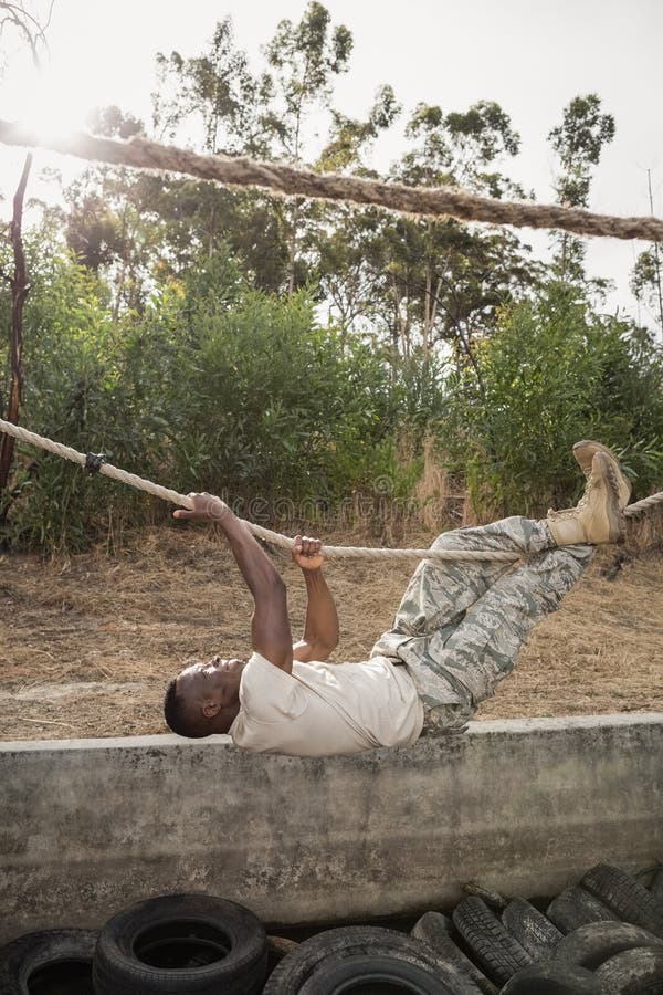 Military Soldiers Climbing Rope during Obstacle Course Training Stock ...