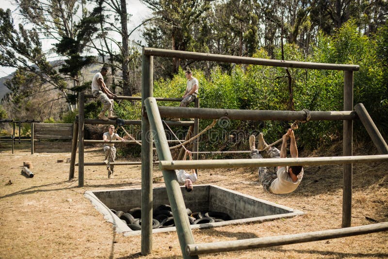 Young Military Soldiers Practicing Rope Climbing during Obstacle Course ...