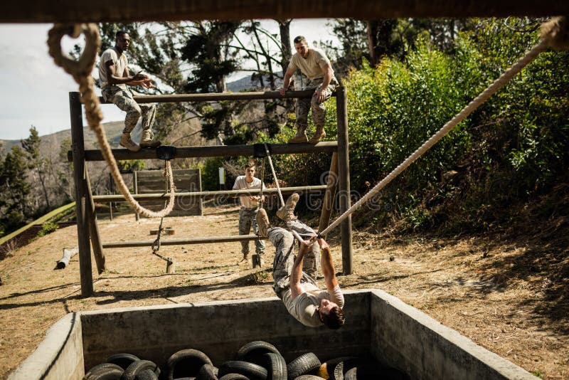 Young Military Soldiers Practicing Rope Climbing during Obstacle Course ...