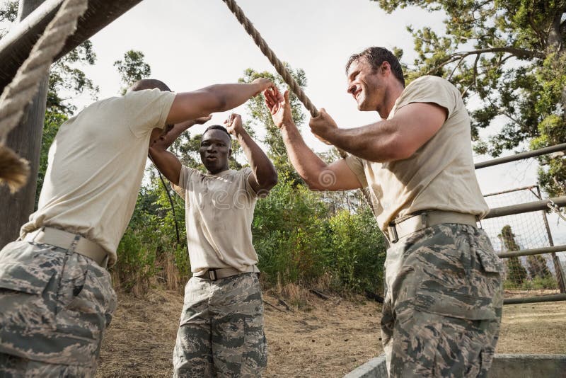 Young Military Soldiers Practicing Rope Climbing during Obstacle Course ...