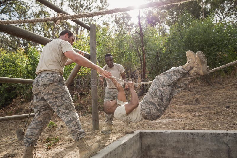 Young Military Soldiers Practicing Rope Climbing during Obstacle Course ...