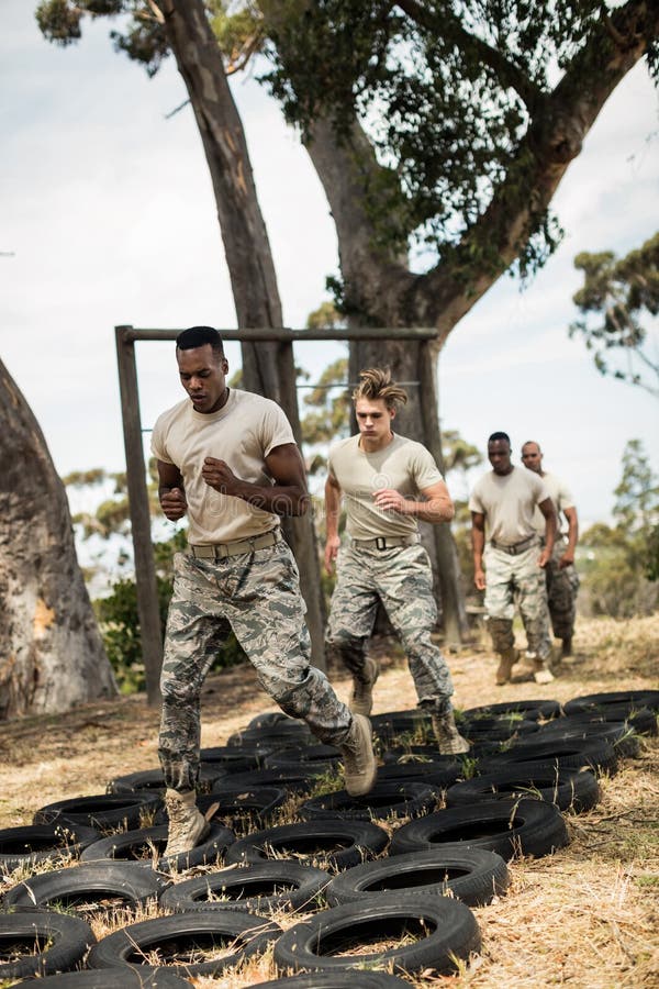 Young Military Soldiers Practicing Rope Climbing during Obstacle Course ...