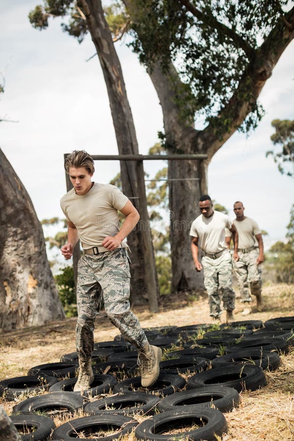 Young Military Soldiers Practicing Rope Climbing during Obstacle Course ...