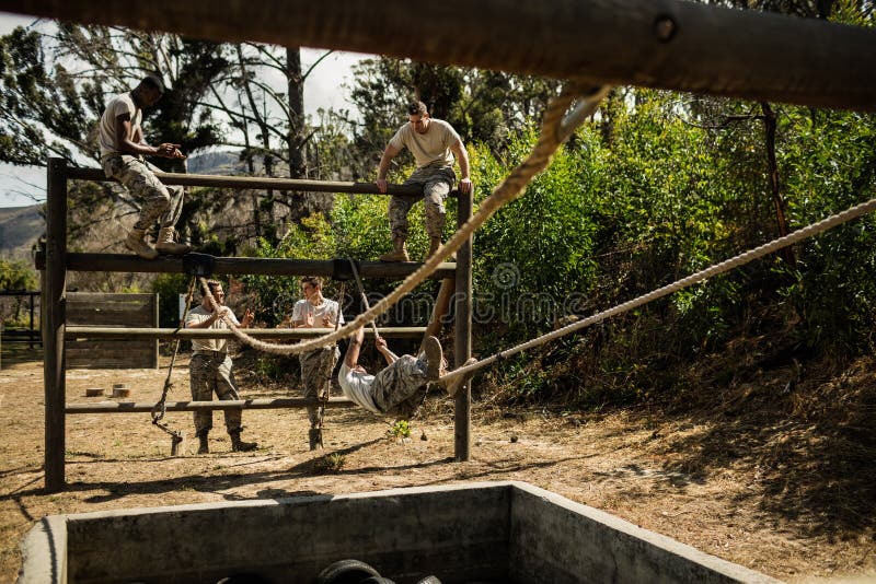 Young Military Soldiers Practising Rope Climbing during Obstacle Course ...