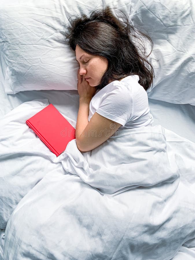 Young Millennial Candid Woman Is Sleeping At Home On A White Stripped