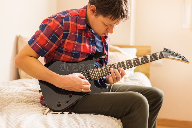 Millenial Man Playing, Practicing Electric Guitar at Home Stock Photo ...