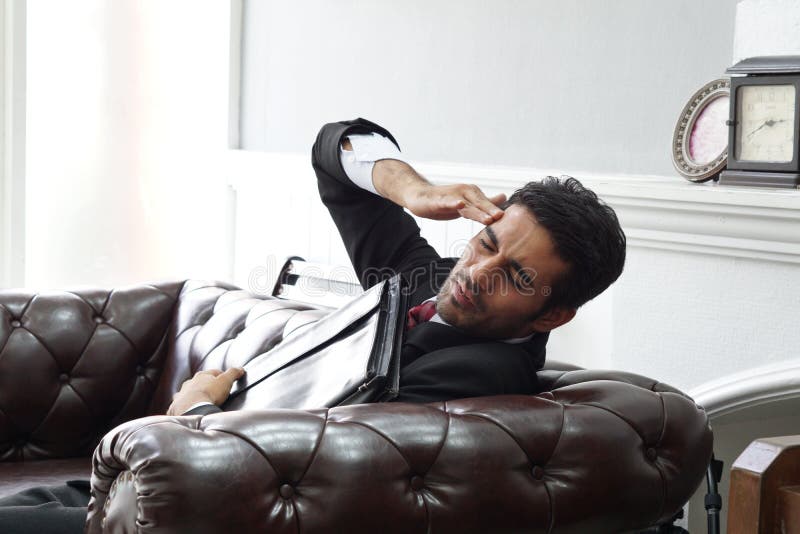 Young Mixed-race Business Man Tired from Work while on the Couch ...