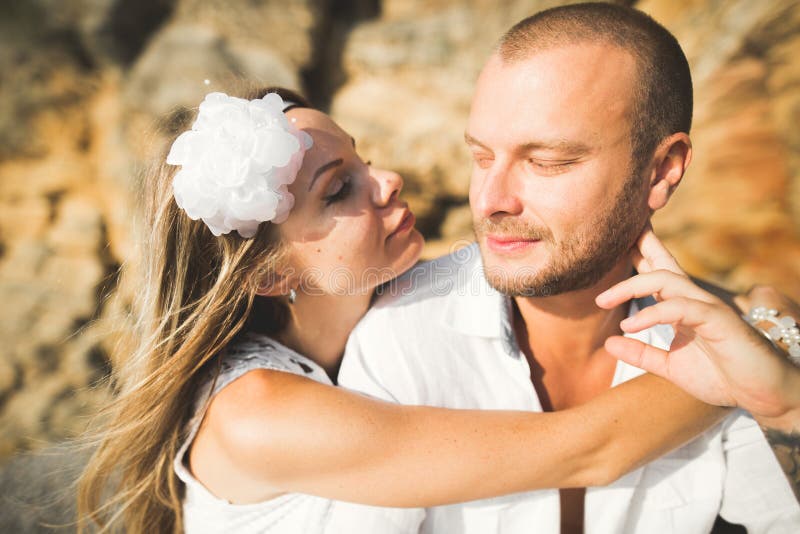 Young Models Couple Posing on the Beach with Stones Stock Image - Image ...