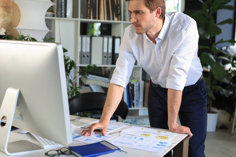 Young Modern Business Man Analyzing Data Using Computer while Working in the Office. Stock Photo ...