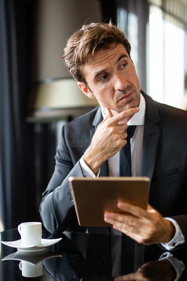 Young Modern Business Man Working Using Digital Tablet while Sitting in ...