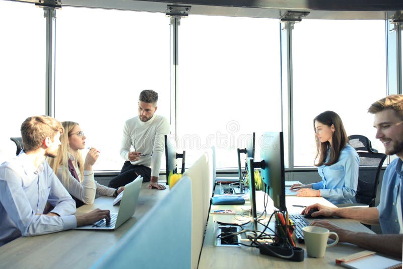Young Modern Colleagues in Smart Casual Wear Working Together while ...
