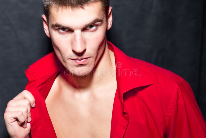 Young Modern Macho Man in Red Shirt is Posing Stock Photo - Image of ...