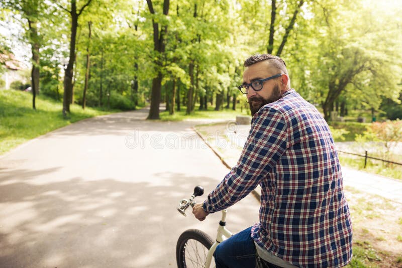 Young Modern Man Turning Back on Bicycle Stock Image - Image of ...