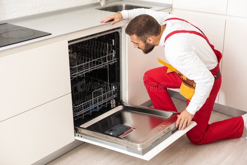Young Modern Serviceman in Worker Suit during the Repairing of the ...