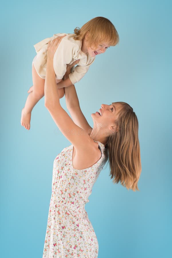 Mother Lifts Child on Hands Outdoor Stock Image - Image of adorable ...