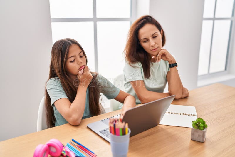 Young Mother and Daughter Doing Homework at Home Serious Face Thinking ...