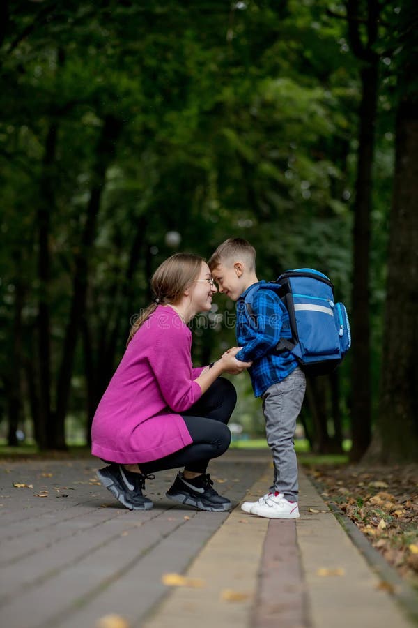 Young Mother Embraces Her Excited First Class Son on the Way To School ...