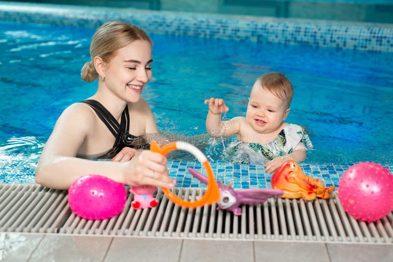 Young Mother and Her Baby Daughter Play in the Pool Stock Photo - Image ...