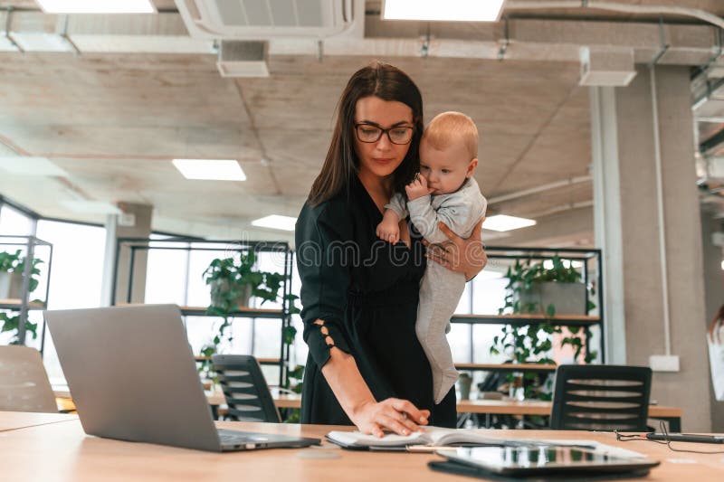 Young Mother with Her Little Baby Son is in the Office Stock Image ...