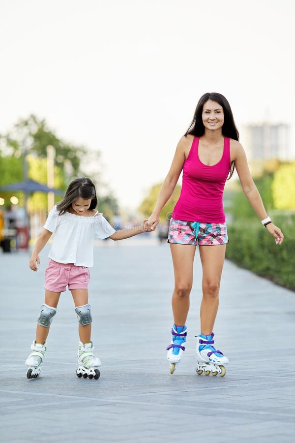 Young Mother and Her Little Daughter Rollerskating Stock Image - Image ...
