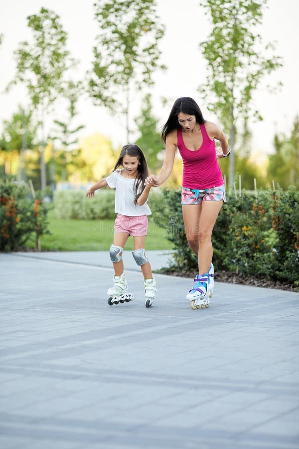 Young Mother and Her Little Daughter Rollerskating Stock Photo - Image ...