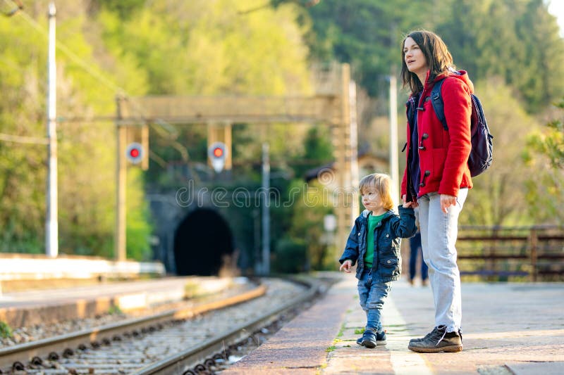 Young Mother and Her Toddler Son on a Railway Station. Mom and Little ... Young Mother and Her Toddler Son on a Railway Station. Mom and Little ...