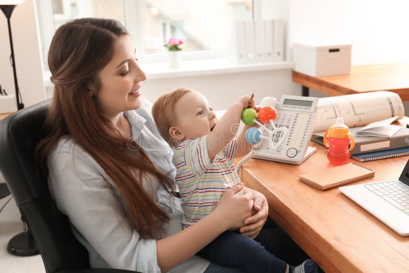 Young Mother Holding Baby while Working in Office Stock Photo - Image ...