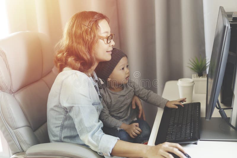 Young Mother in Home Office with Computer and Her Son Stock Image ...