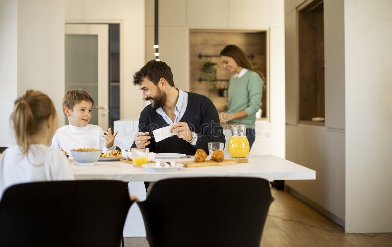 Young Mother Preparing Breakfast for Her Family in the Kitchen Stock ...