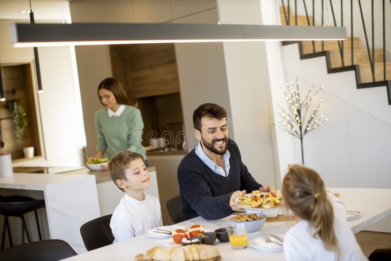 Young Mother Preparing Breakfast for Her Family in the Kitchen Stock ...