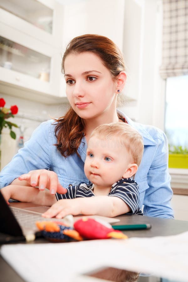 Young Mother Working with Her Baby Stock Image - Image of parent ...