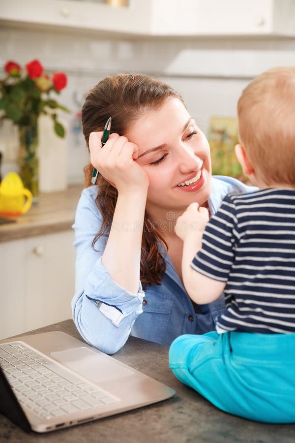 Young Mother Working with Her Baby Stock Image - Image of kitchen ...