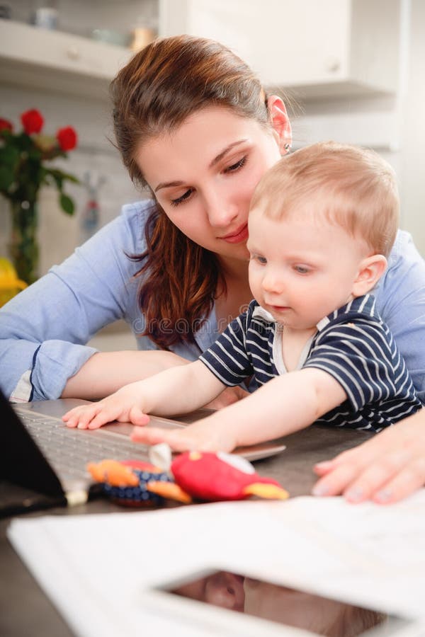 Young Mother Working with Her Baby Stock Image - Image of kitchen ...