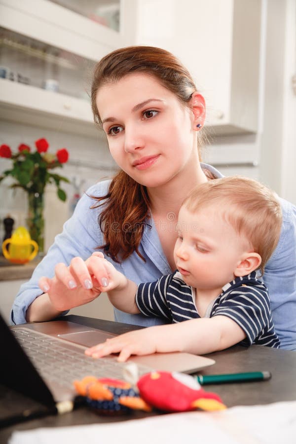 Young Mother Working with Her Baby Stock Image - Image of kitchen ...