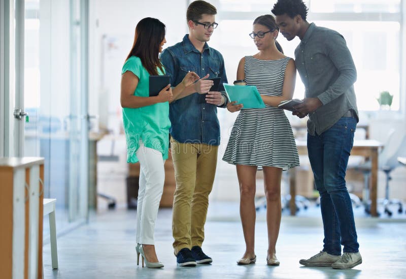 Young Movers and Shakers in the Office. a Group of Coworkers Talking ...