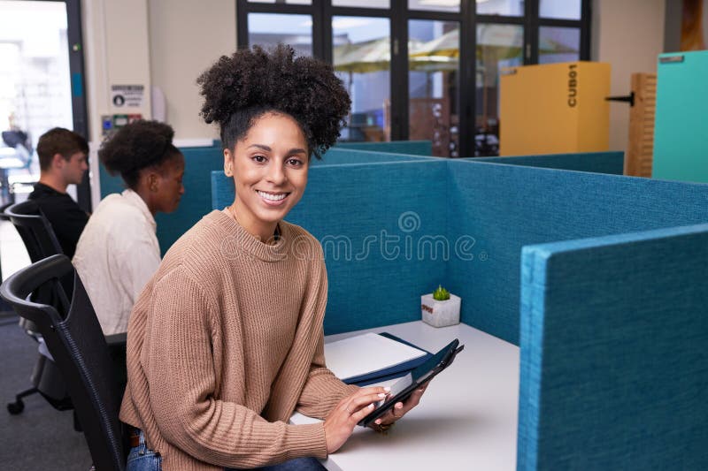 Young Multi-ethnic Woman Using Digital Tablet in Shared Workplace Stock ...
