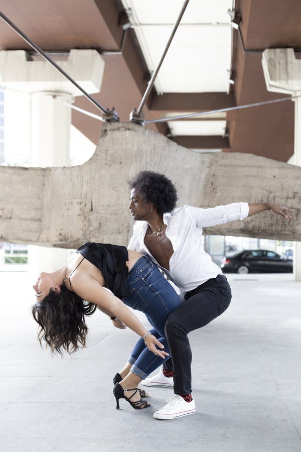 Young Multiethnic Couple Masterfully Executing Complicated Dance Figure ...