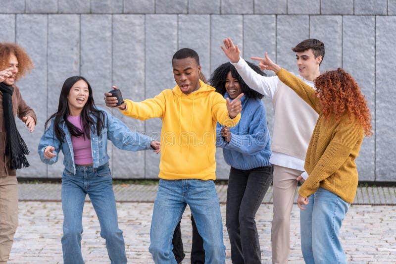 Young Multiethnic Friends Dancing Together Outdoors. Stock Photo ...
