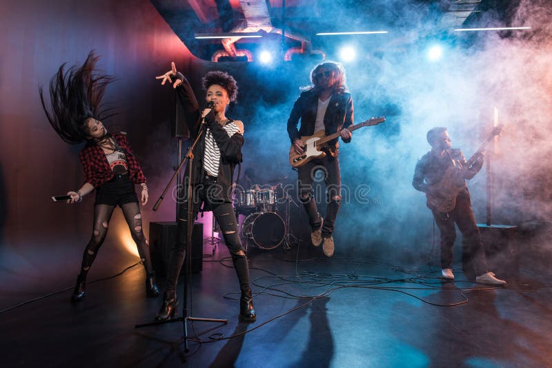 Young Multiethnic Rock and Roll Band Performing Hard Rock Music Stock ...